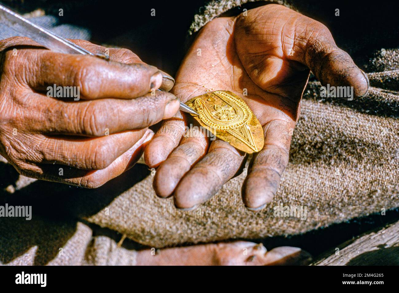Goldsmith working on the typical jewellery of the women in village ...