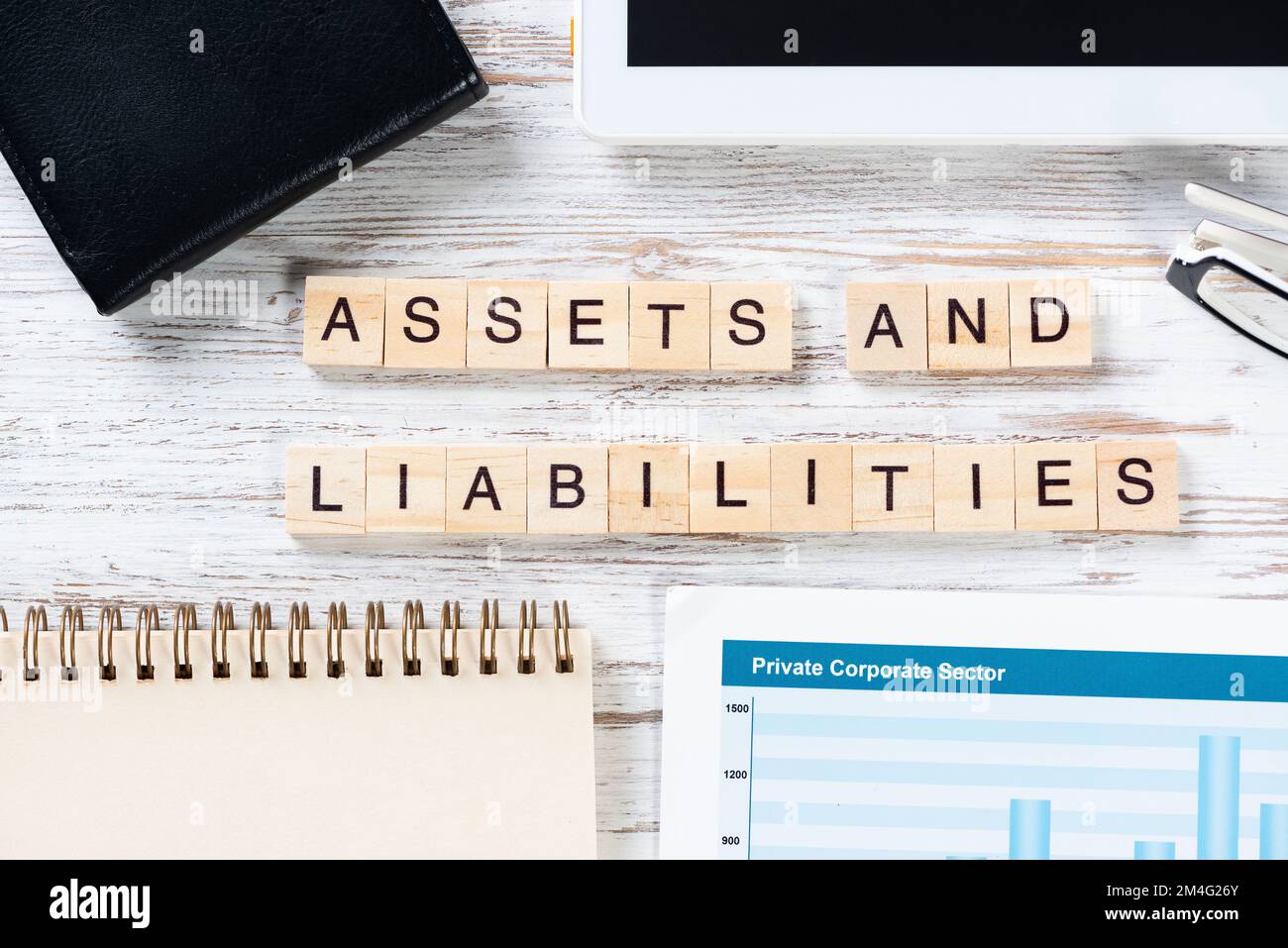 Assets and liabilities concept with letters on cubes Stock Photo - Alamy