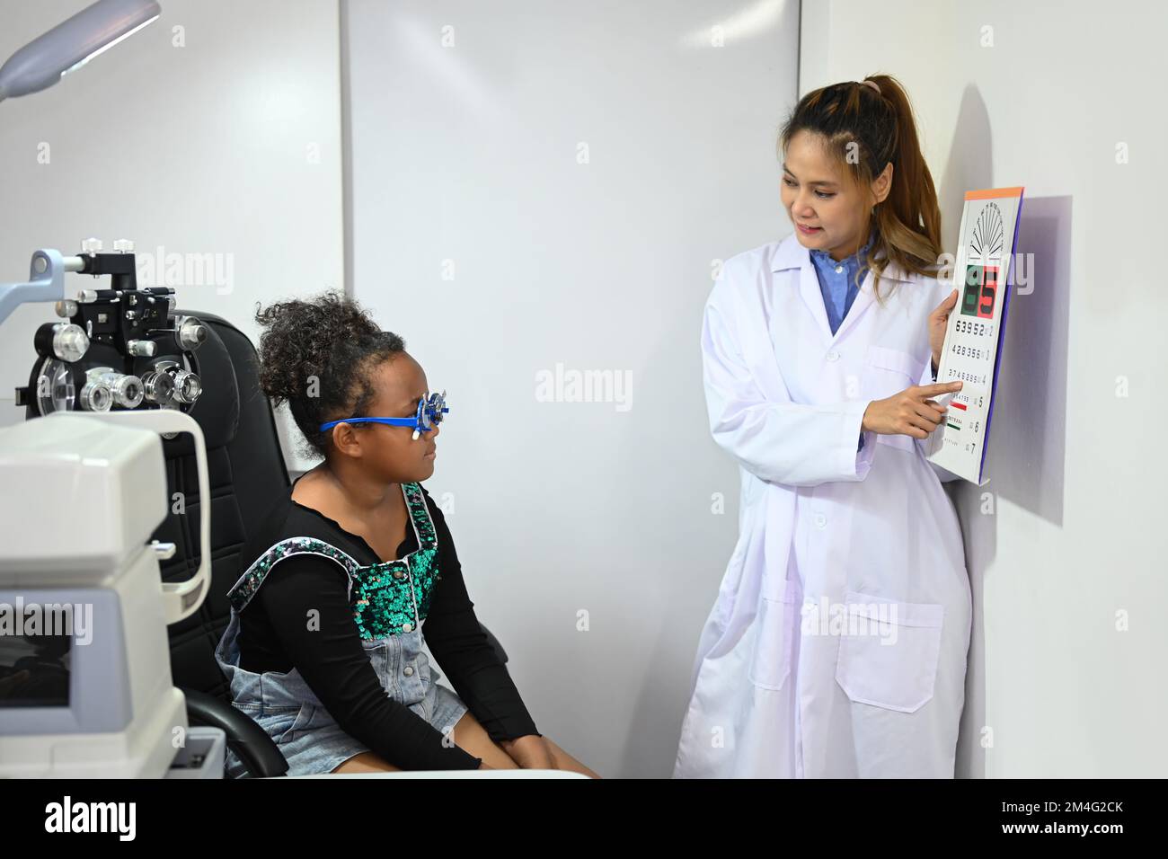 Image of young woman undergoing vision check with special ophthalmic ...