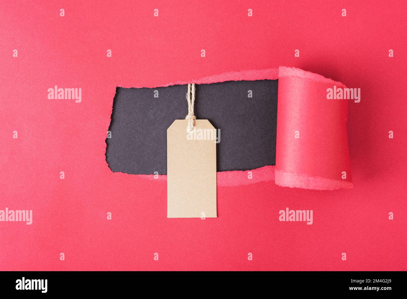 Kraft paper tag on red torn paper background. Black friday, Christmas ...