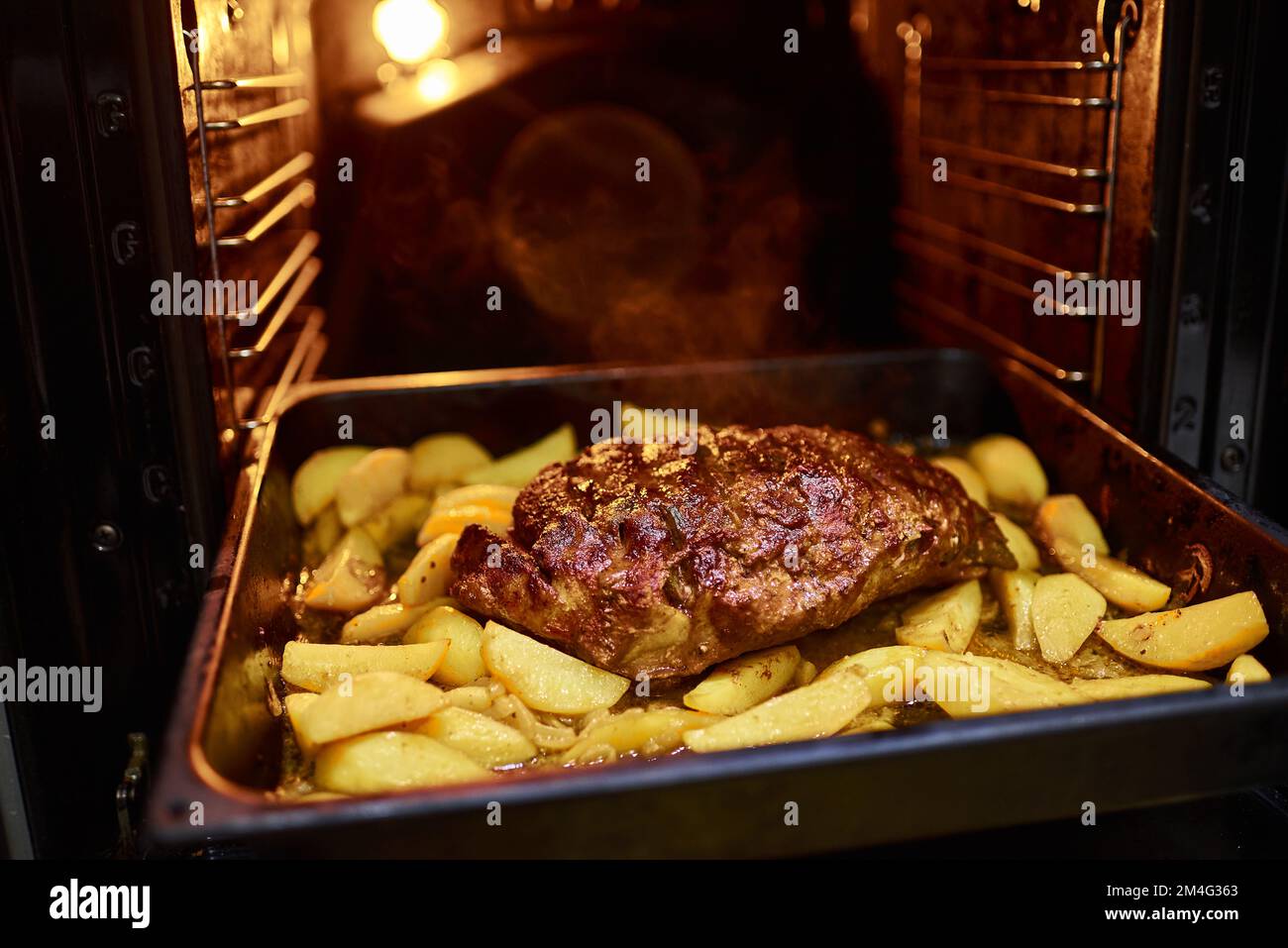 Cooking homemade food in an electric oven. Vegetable stew with potatoes ...