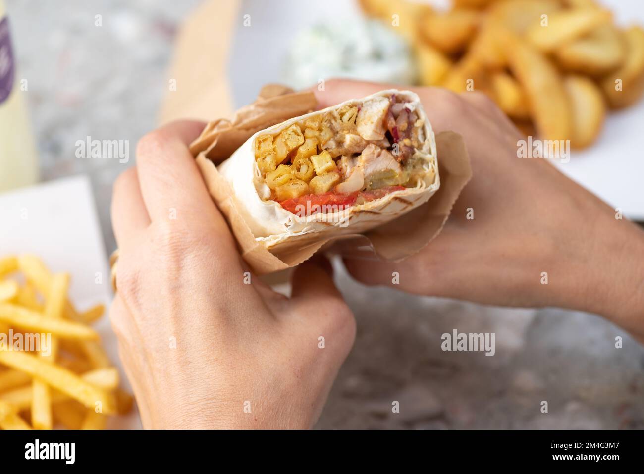 Gyro shawarma sandwich fresh pita bread roll in female hands ...