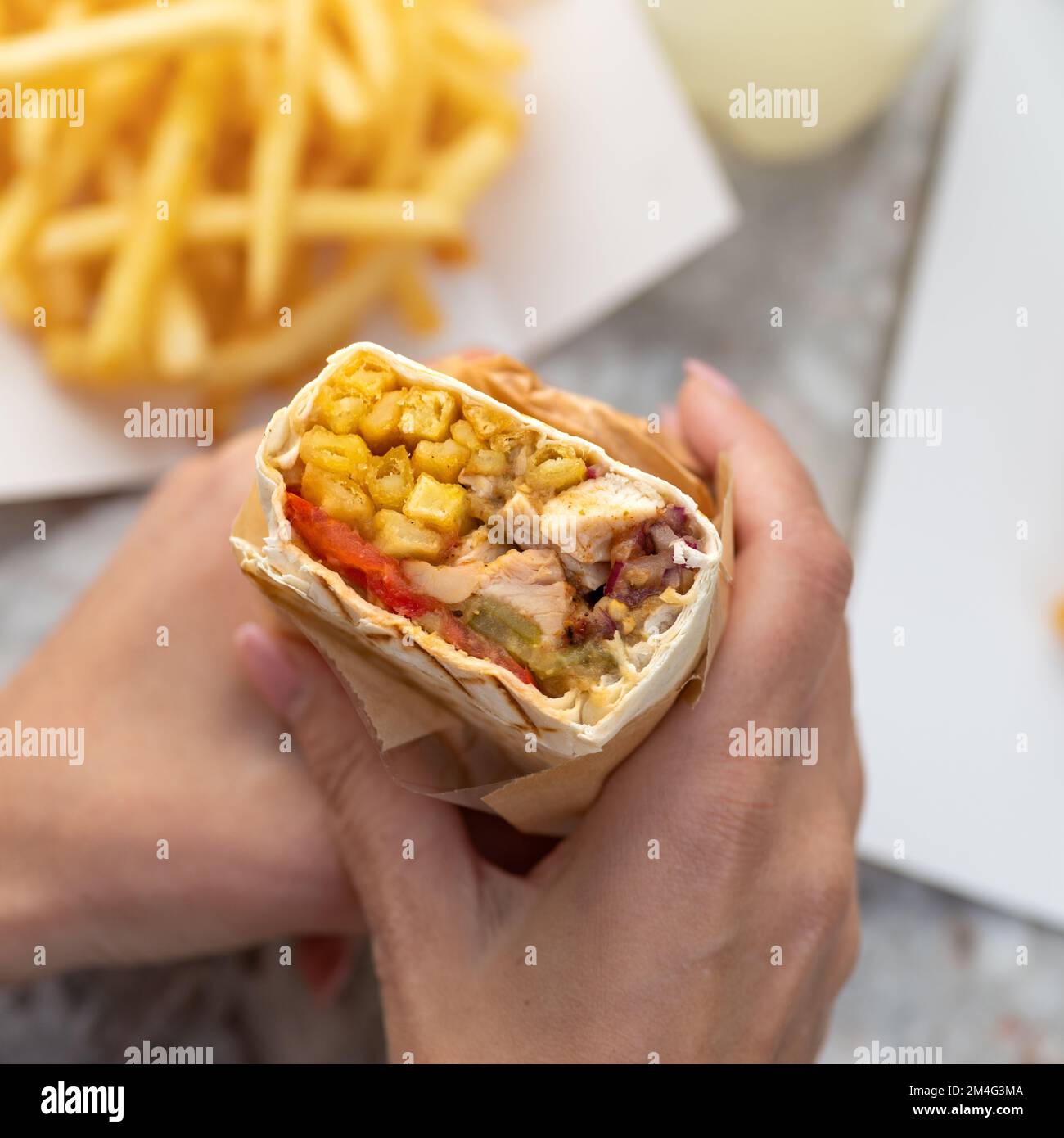 Gyro shawarma sandwich fresh pita bread roll in female hands ...