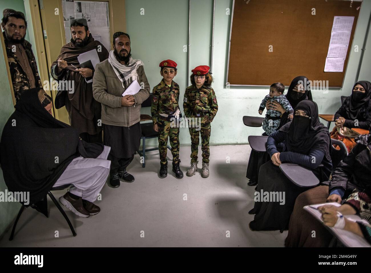 17 November 2022, Afghanistan, Kabul: Taliban stand next to two boys ...