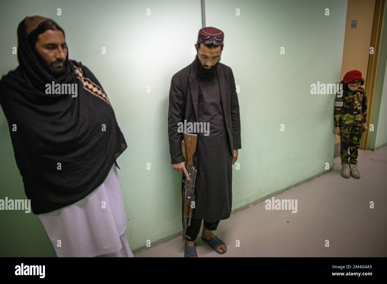 17 November 2022, Afghanistan, Kabul: Taliban stand next to a boy ...