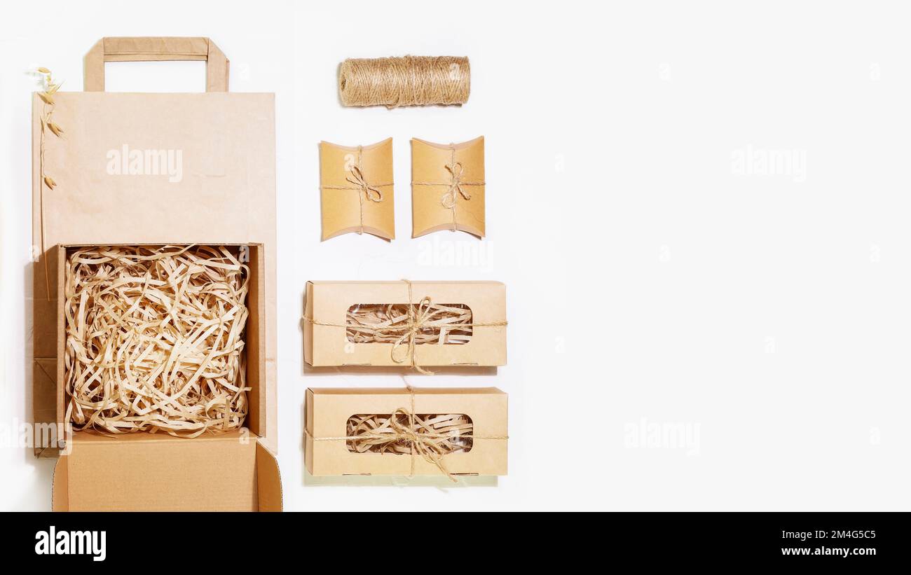 Eco friendly packaging concept. Cardboard boxes with shredded paper ...