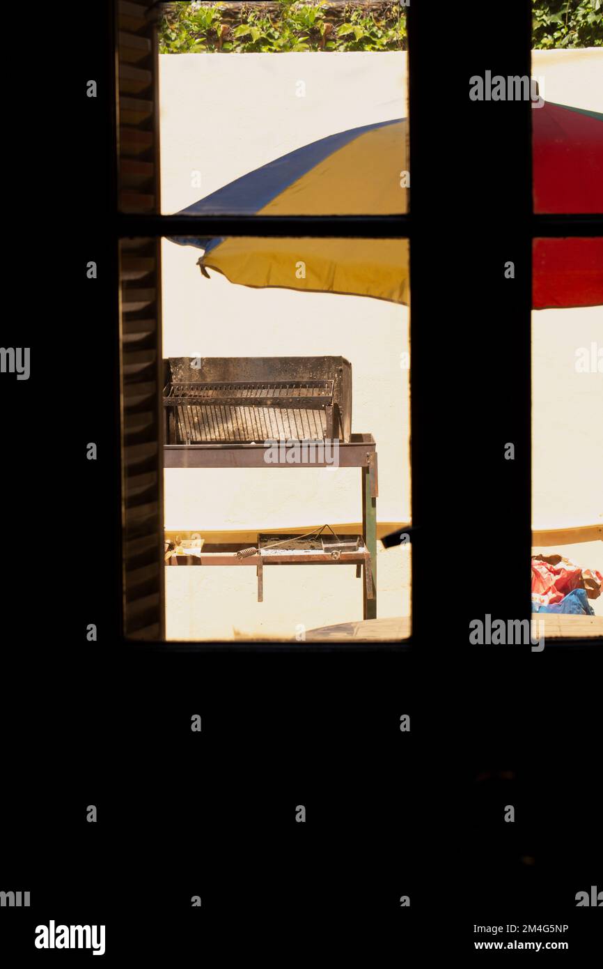 photo from window to the patio with umbrella and barbecue Stock Photo ...