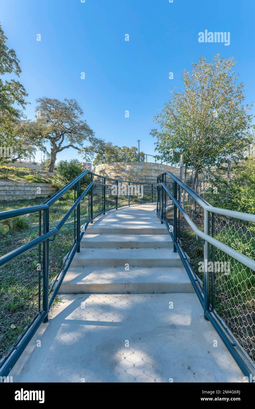Paved pathway with steps and rails for visitors of Waterloo park in ...