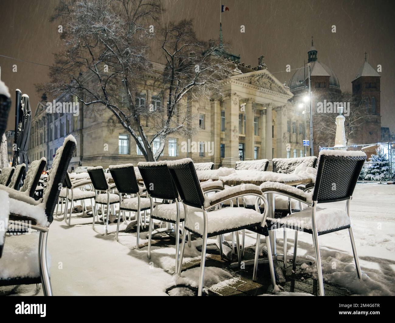 View of a restaurant with chairs and table covered in snow on a cold ...