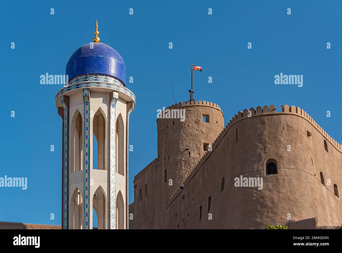 Minaret of Al Khor Mosque and Al-Mirani Fort, Muscat, Oman Stock Photo ...