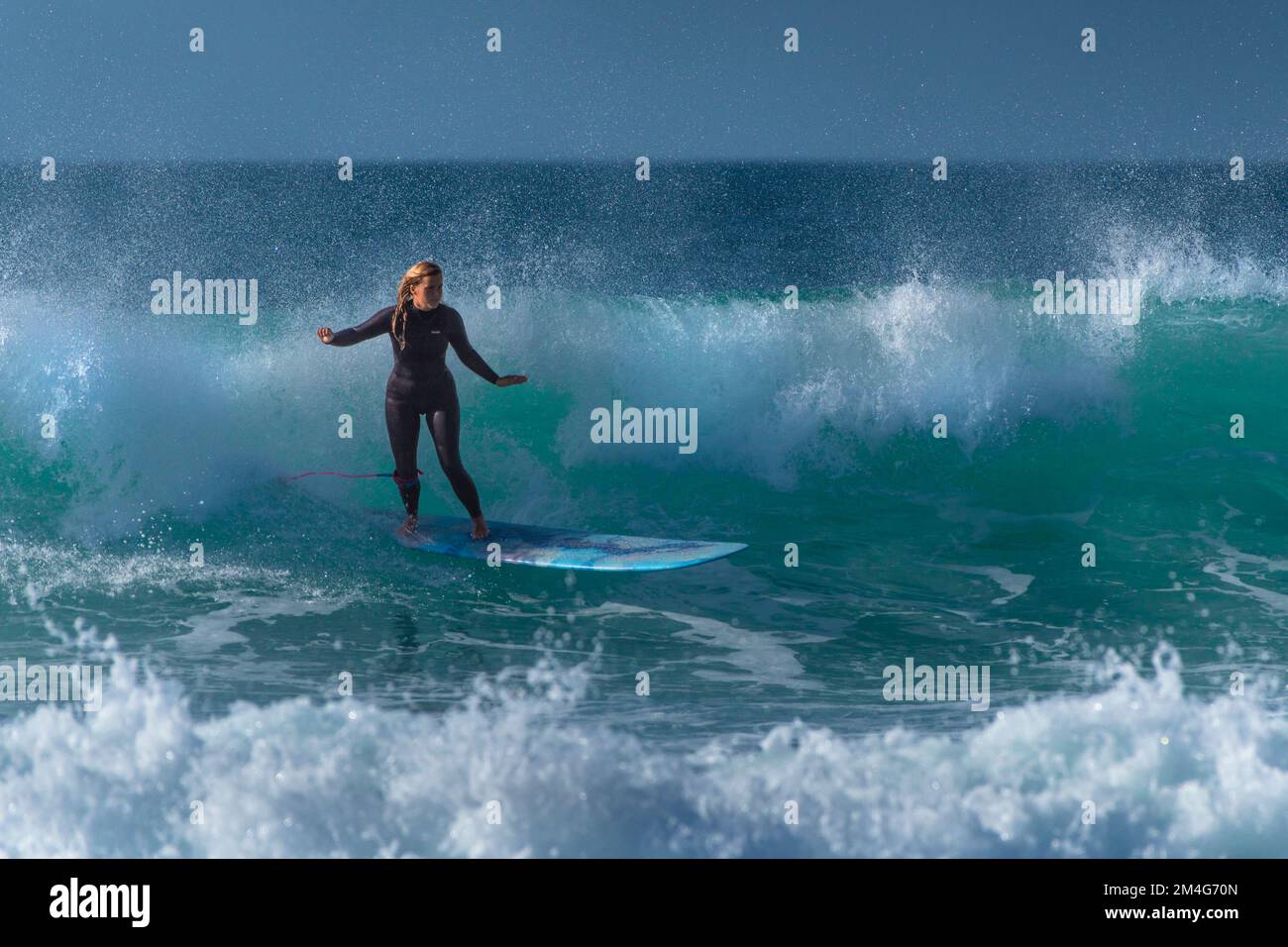 Spectaular surfing action as a female surfer rides a wave at Fistral in ...