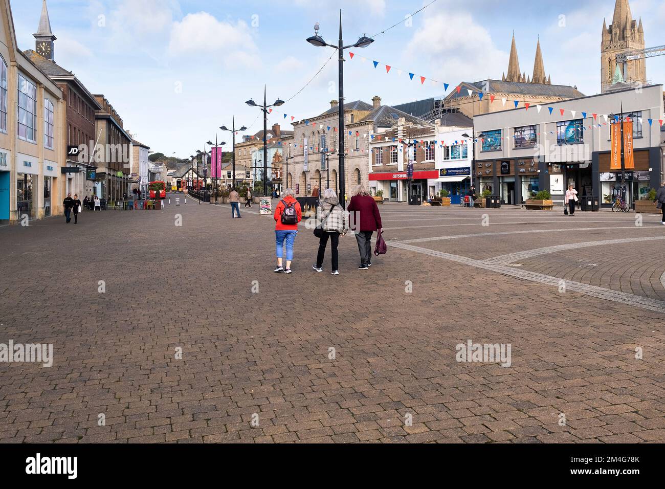 People Shoppers walking across the wide open space historic Lemon Quay ...