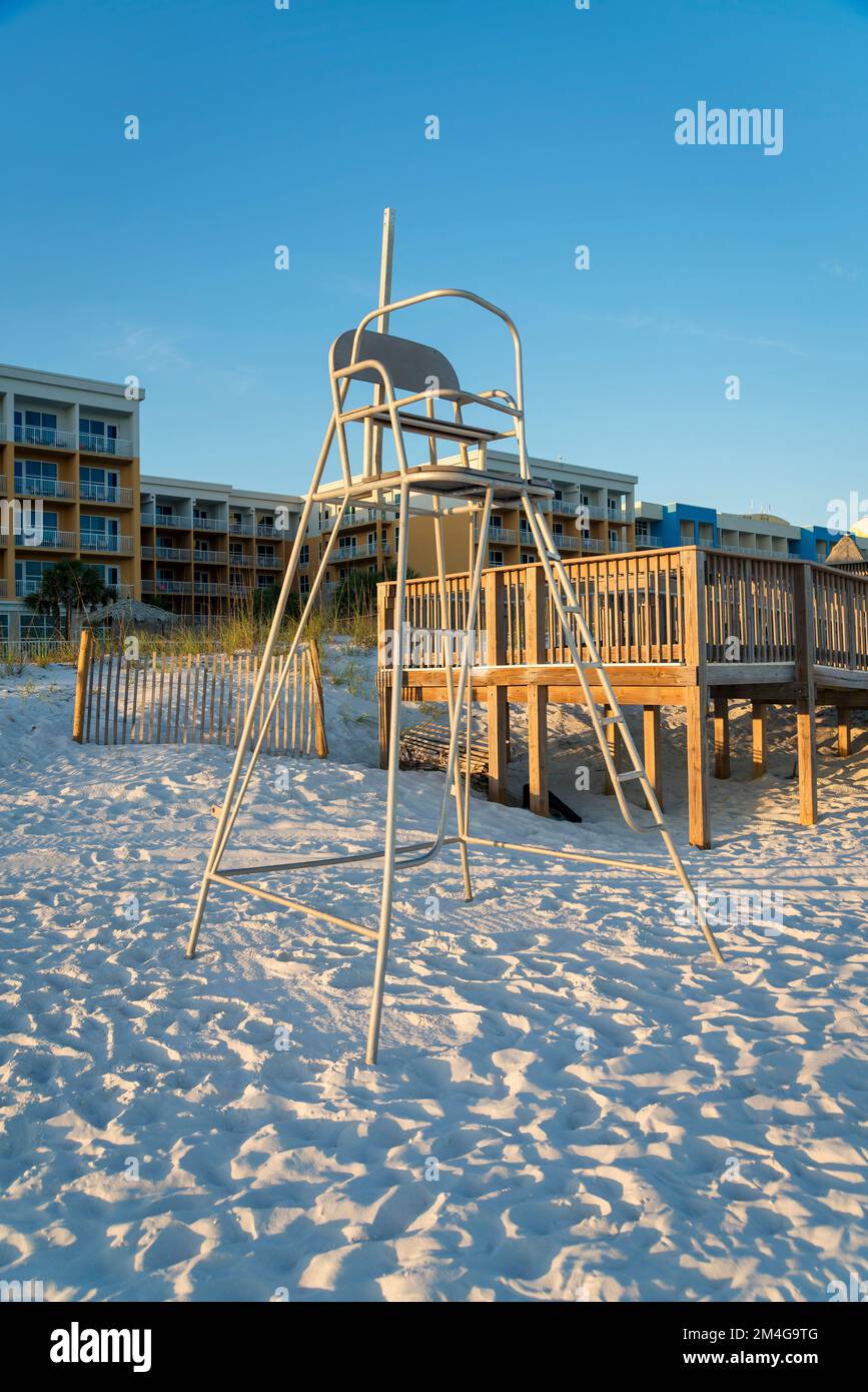 Lifeguard chair on a white sand beach near the wood foothpath with ...
