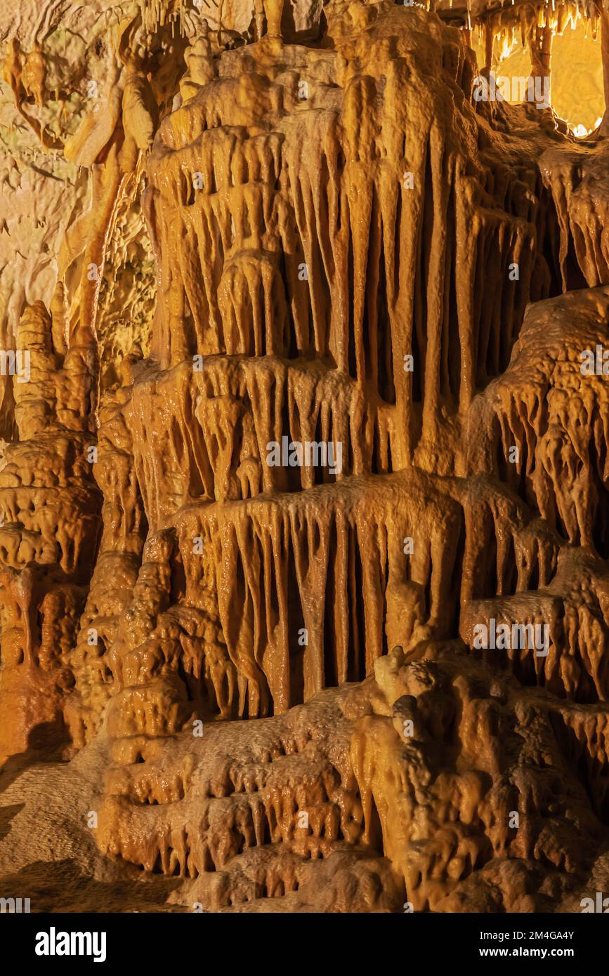 Column with red stalactites on the way into the Postojna cave Stock ...