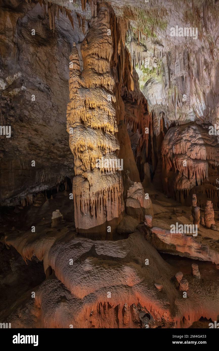 A column with stalactites in intense colors in the Postojna cave Stock ...