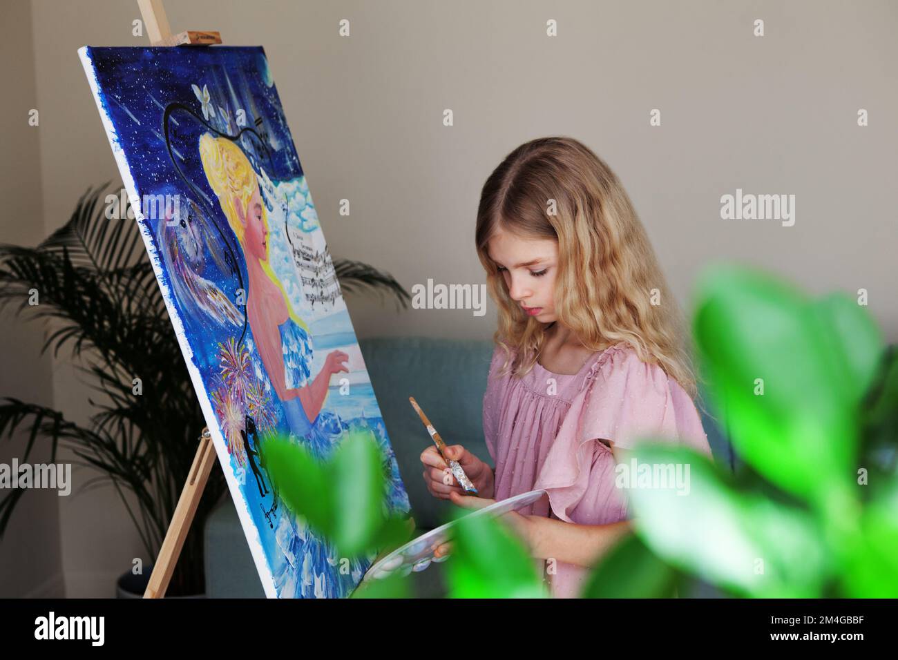 Portrait of cute teenage girl artist paints picture indoors Stock Photo ...
