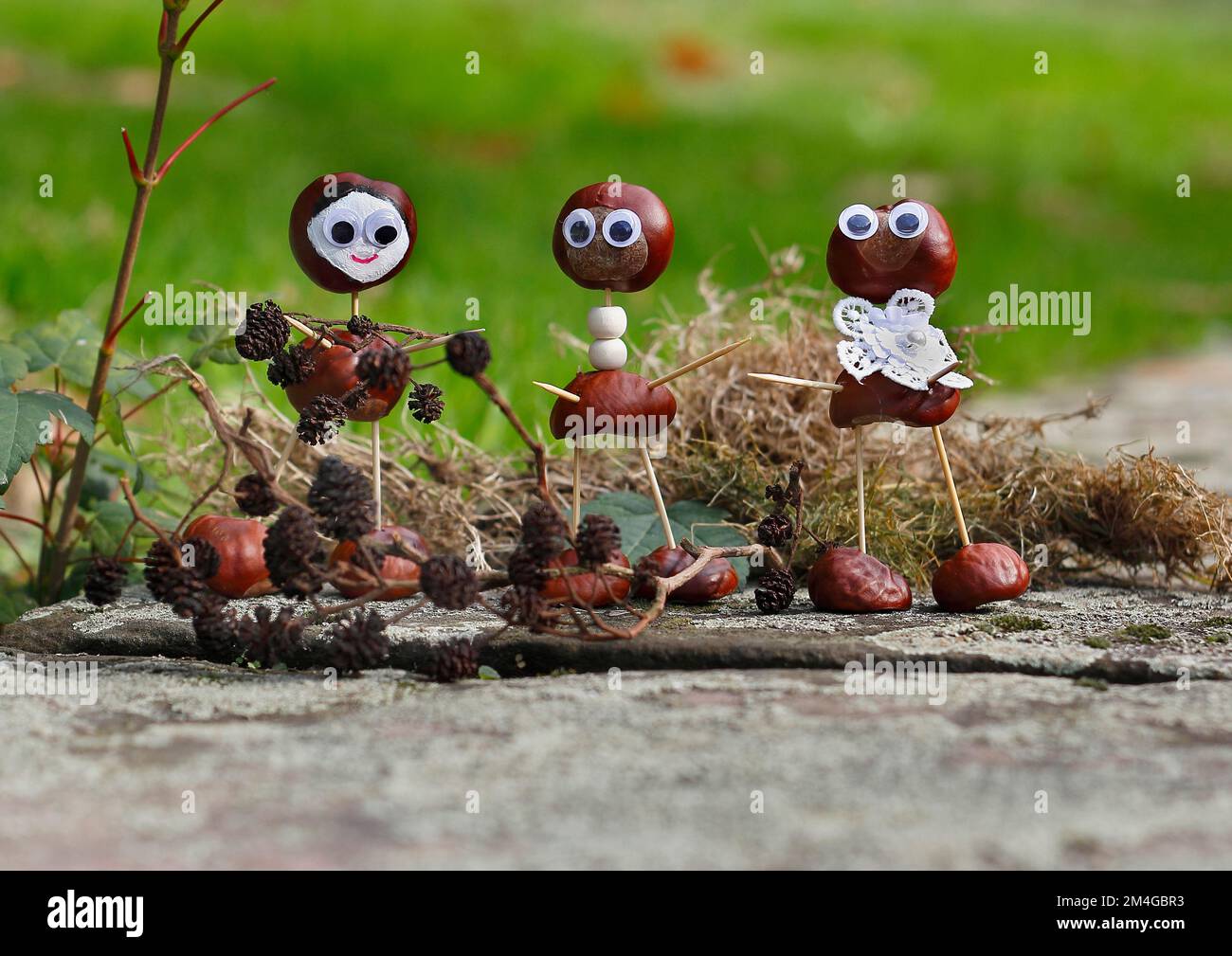 three chestnut figures in the garden Stock Photo - Alamy
