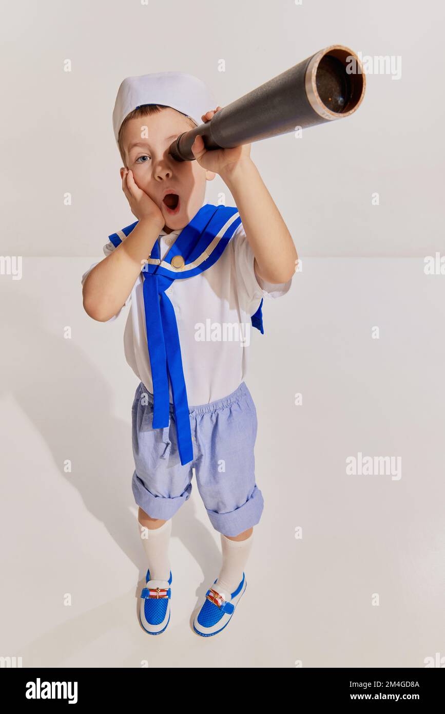 Portrait of little boy, child in image of seaman in vest posing with ...