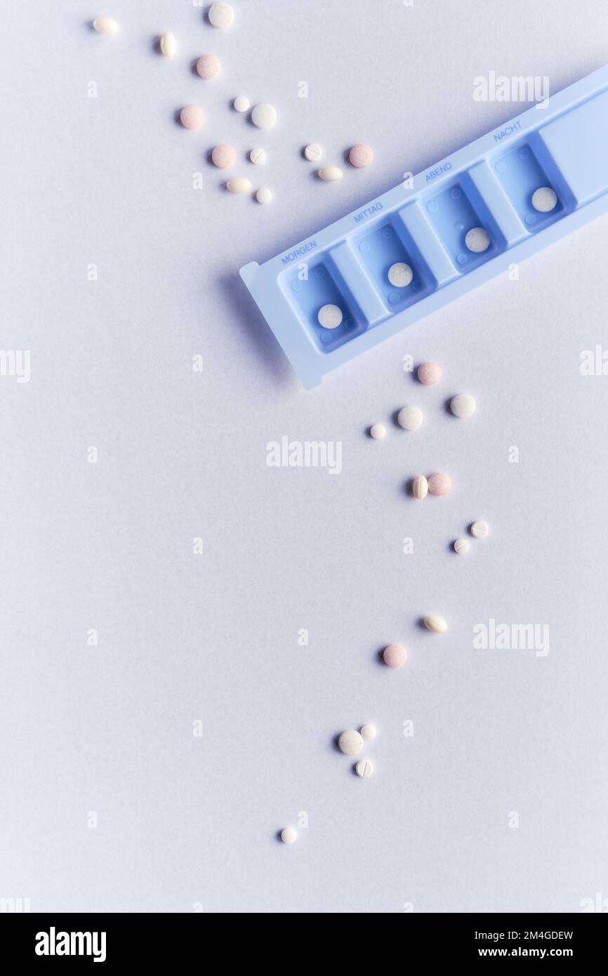 Tablet, pill dispenser and tablets. Flat lay, top view on off white ...