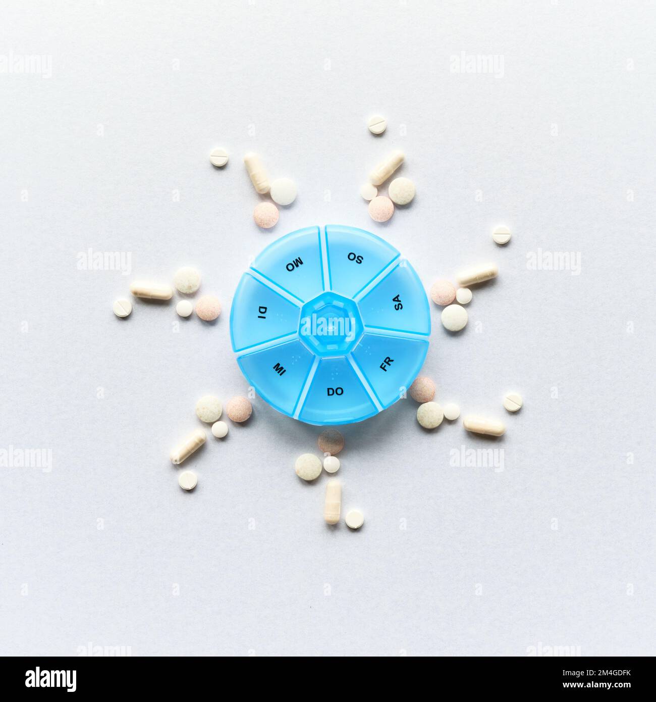 Tablet, pill dispenser and tablets. Flat lay, top view on off white ...