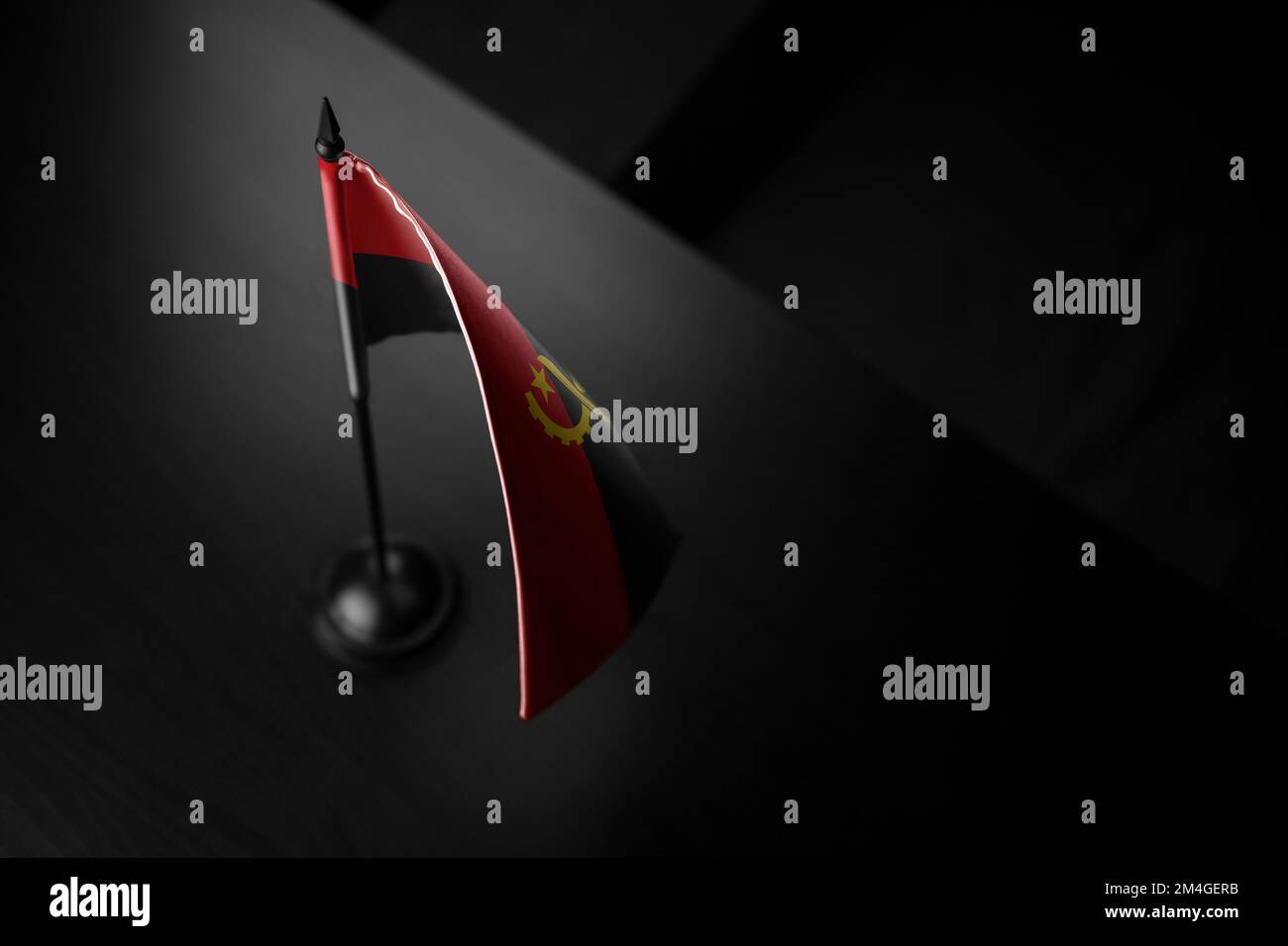 Small national flag of the Angola on a black background Stock Photo - Alamy