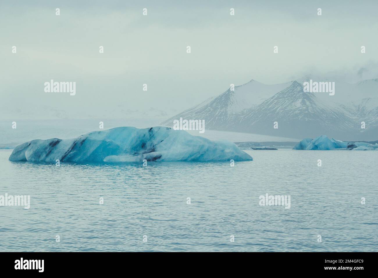 Striped iceberg floating in sea landscape photo Stock Photo - Alamy