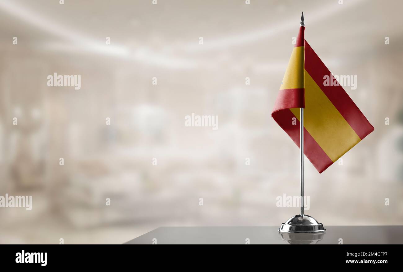 A small Spain flag on an abstract blurry background Stock Photo - Alamy