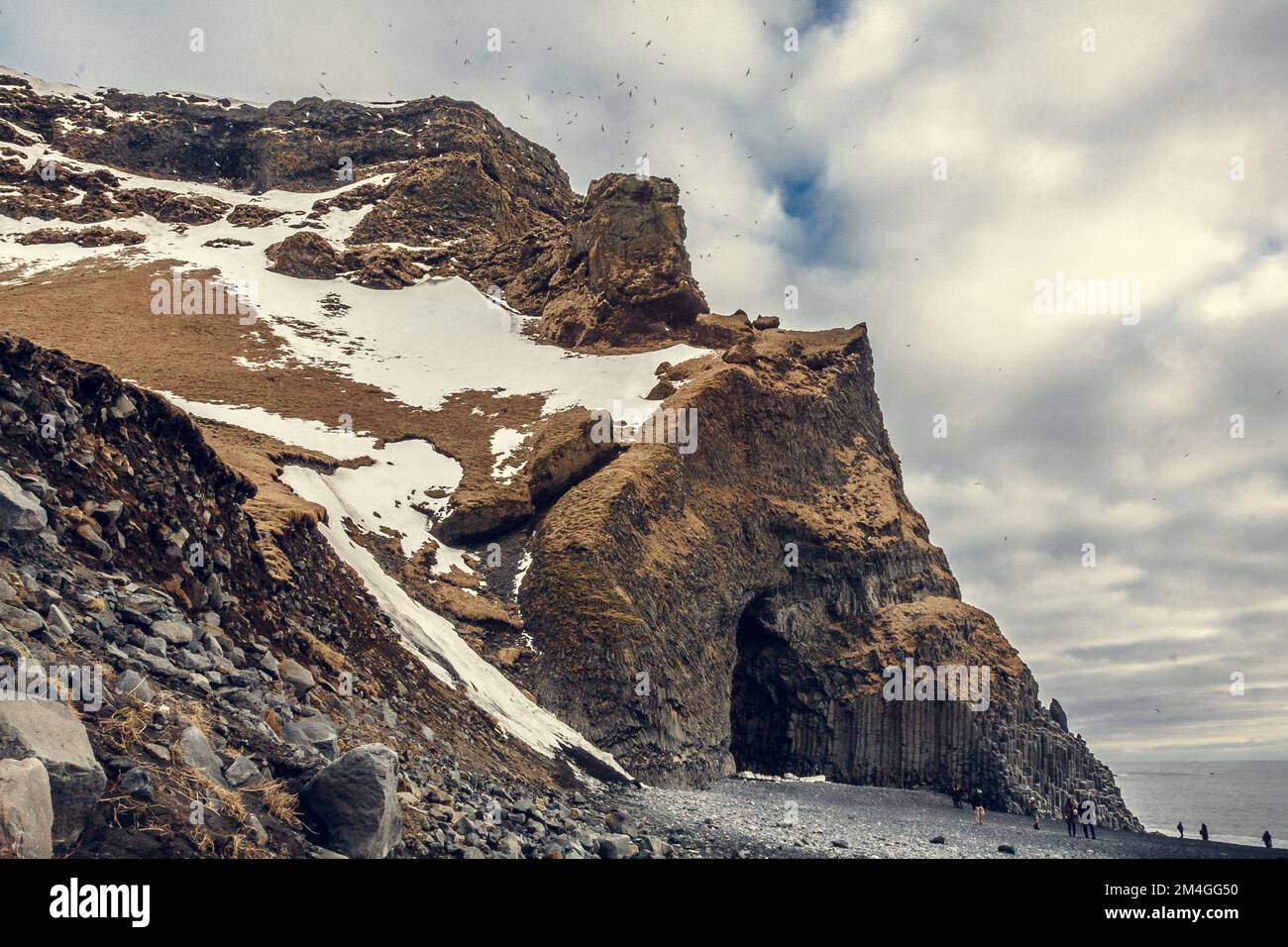 Tourists visiting cave on beach landscape photo Stock Photo - Alamy