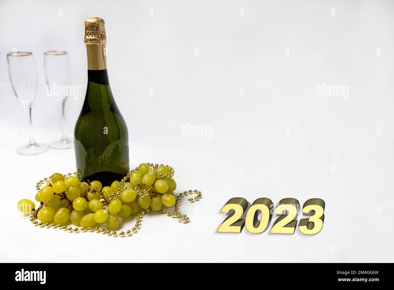 New Year's Eve grapes with champagne bottle, champagne glasses and gold ...