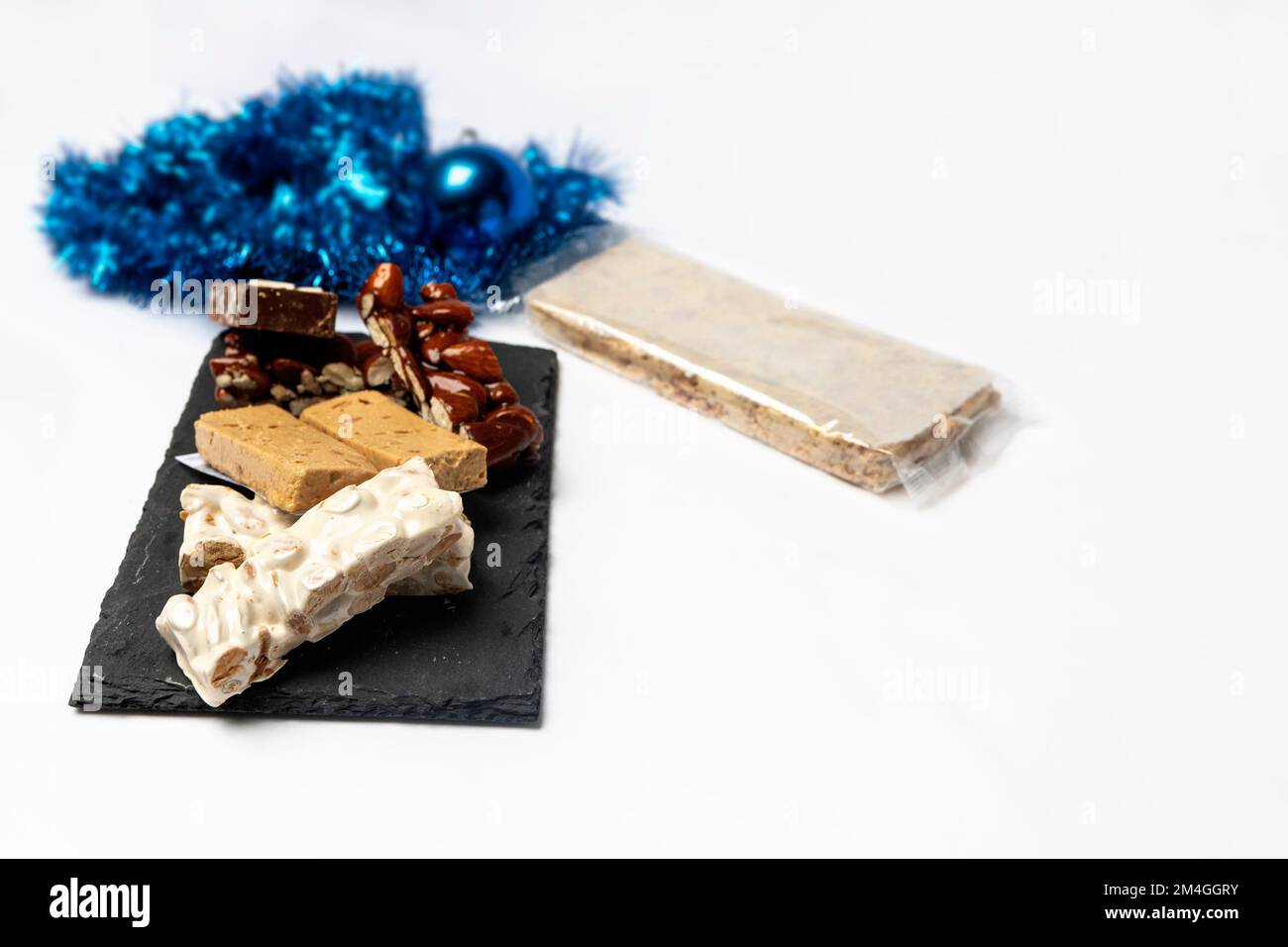 Assortment of Turrones on slate table with white background ...