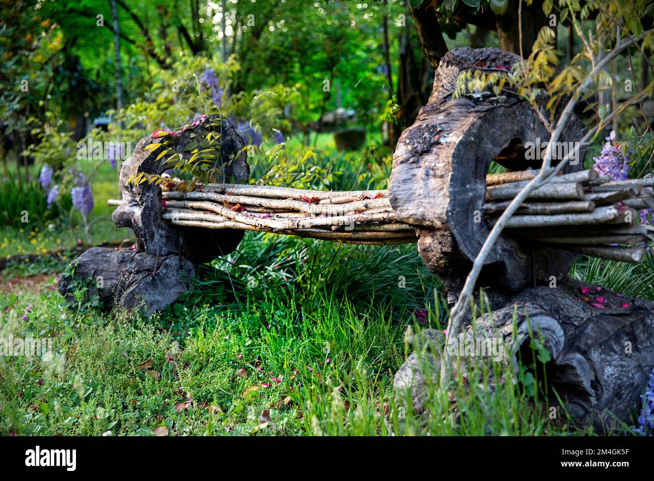 Beautiful garden bench made of tree trunk and tree branches in Guria ...