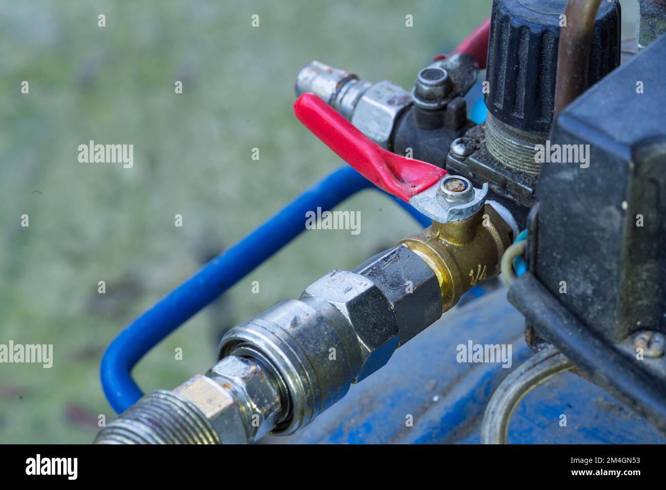 technician hand holding air compressor control valve, red valve Stock ...