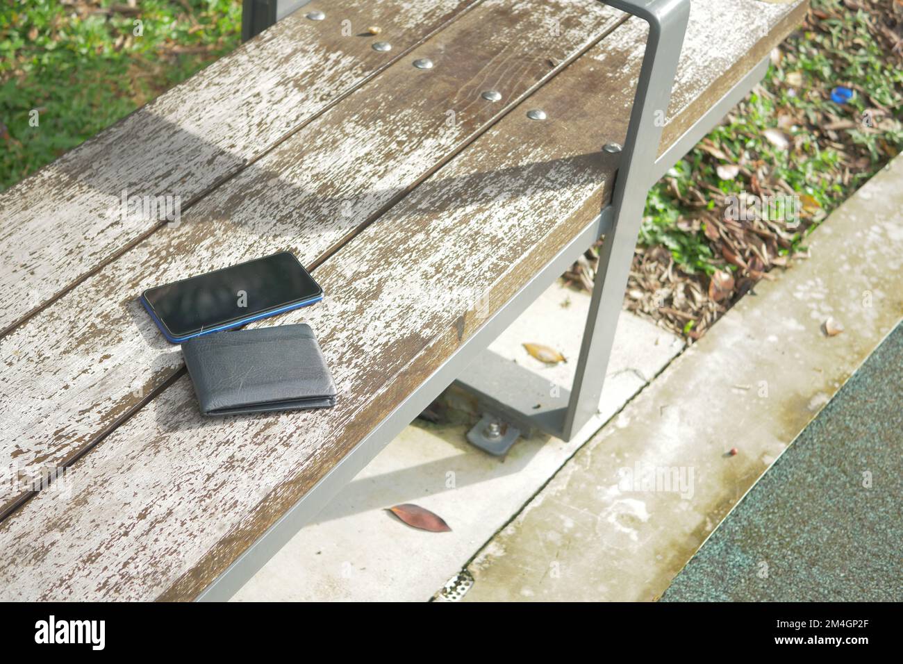 left wallet on a bench in the park Stock Photo - Alamy