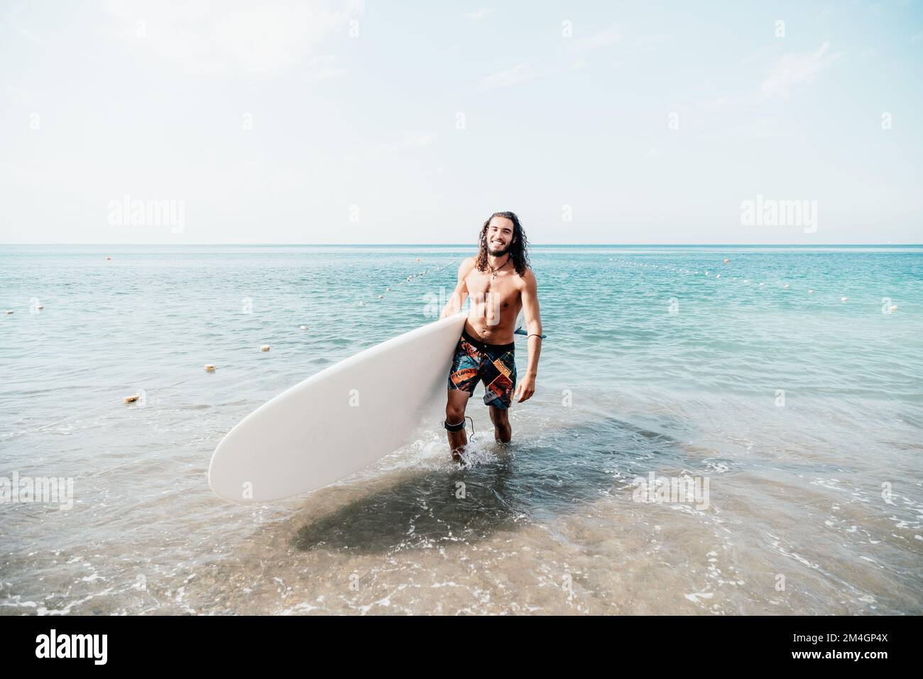 Sea man sup. Asian athlete man swimming in sea and paddleboarding at ...