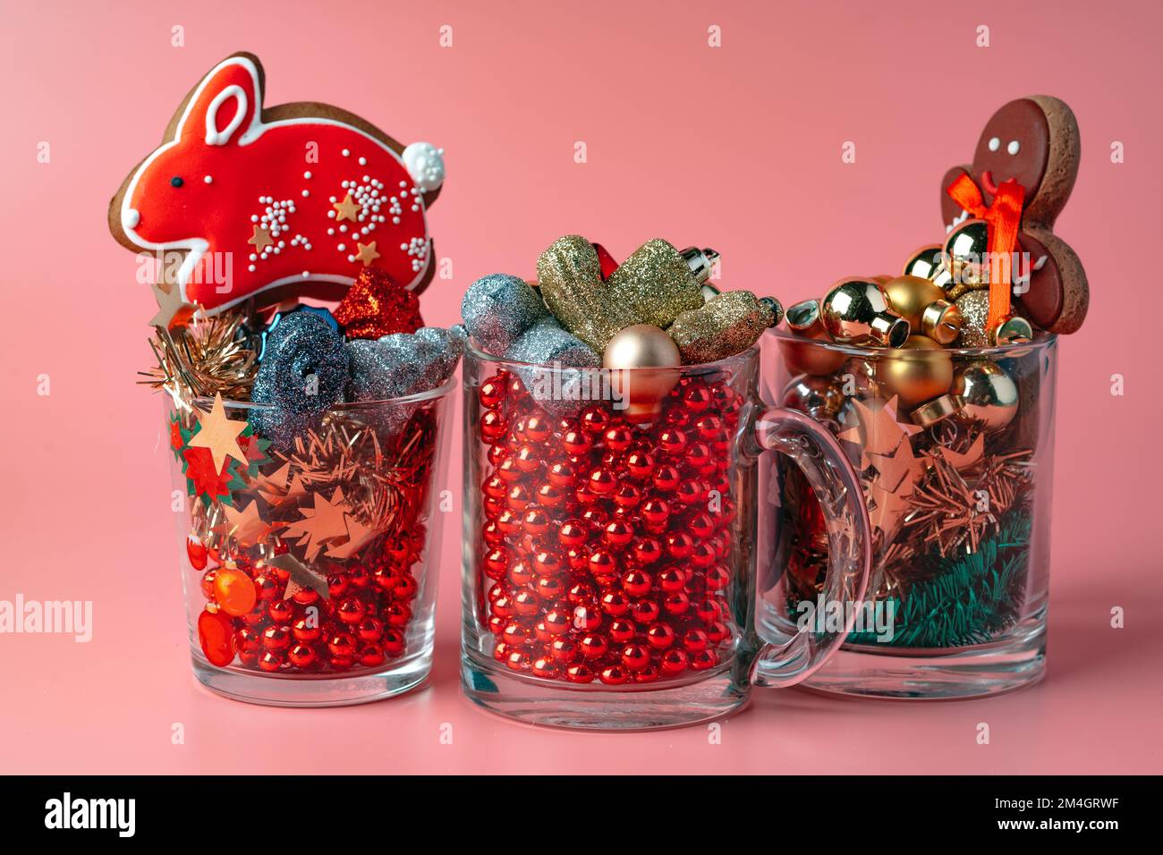 Glass with Christmas decorations on pink pastel background Stock Photo ...