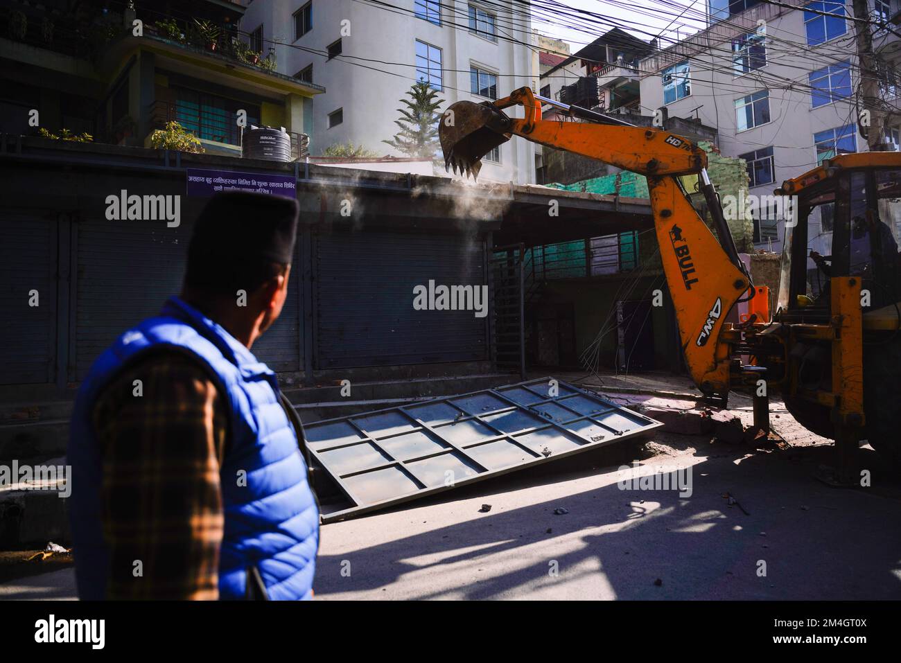 Kathmandu, Nepal. 21st Dec, 2022. A man watches as the city police ...