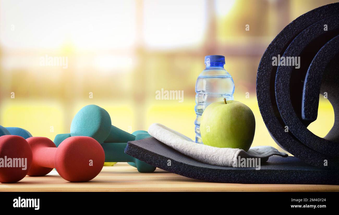 Healthy lifestyle with home sport equipment on wooden slatted floor and ...