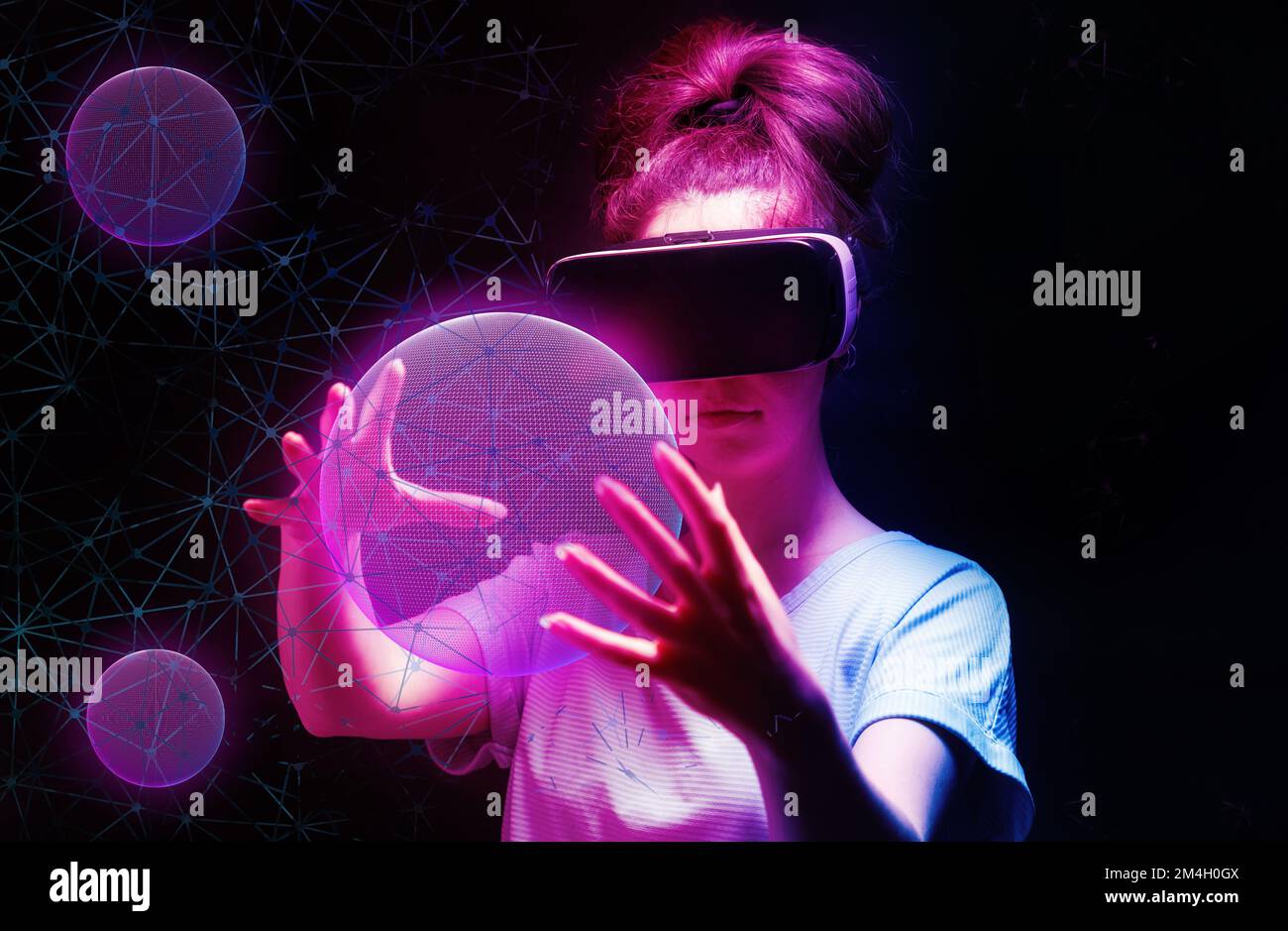 Portrait of young woman in VR glasses creates 3D simulation of pink ...