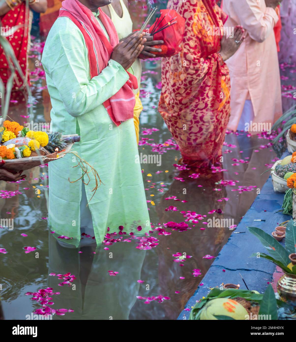 man devotees with religious offerings for sun god during Chhath ...