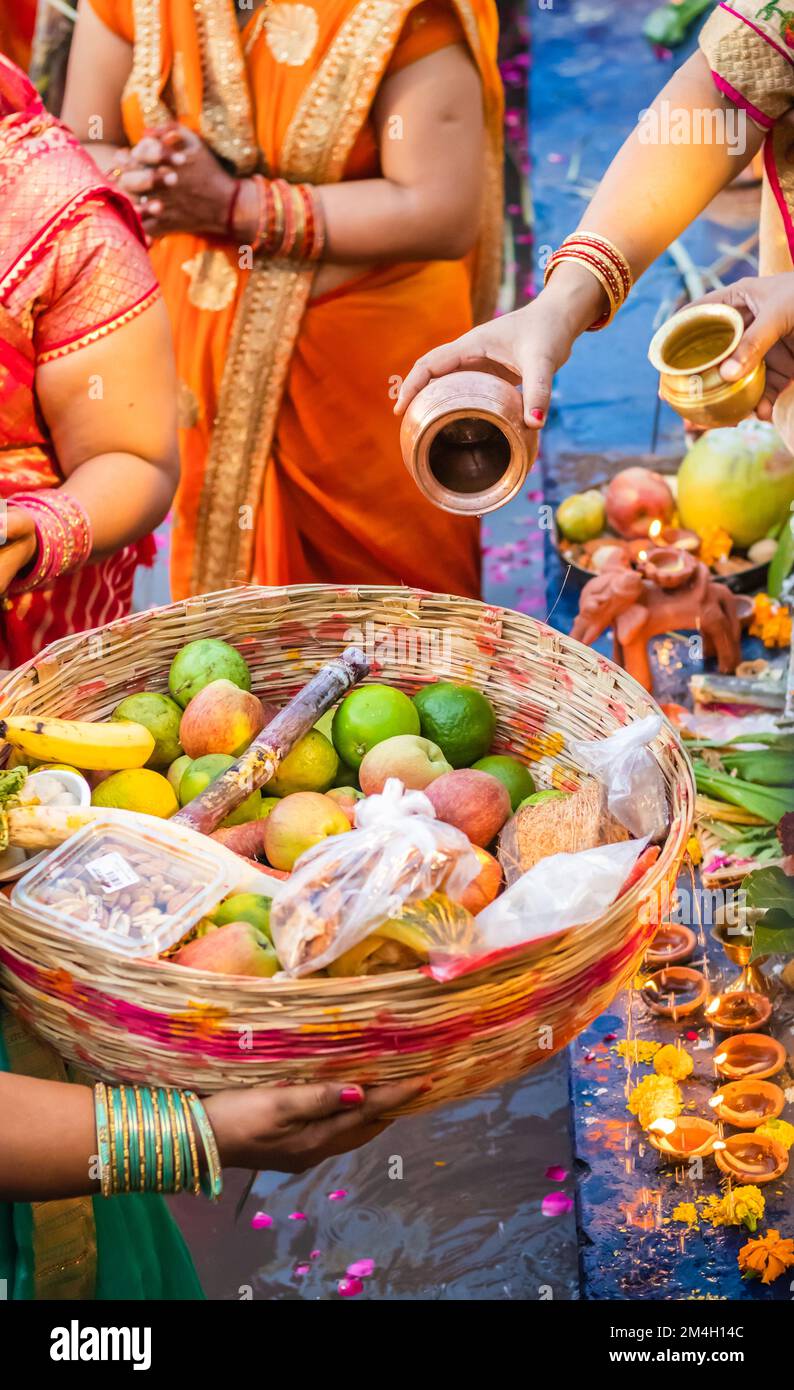 devotee praying with religious offerings for sun god in Chhath festival ...