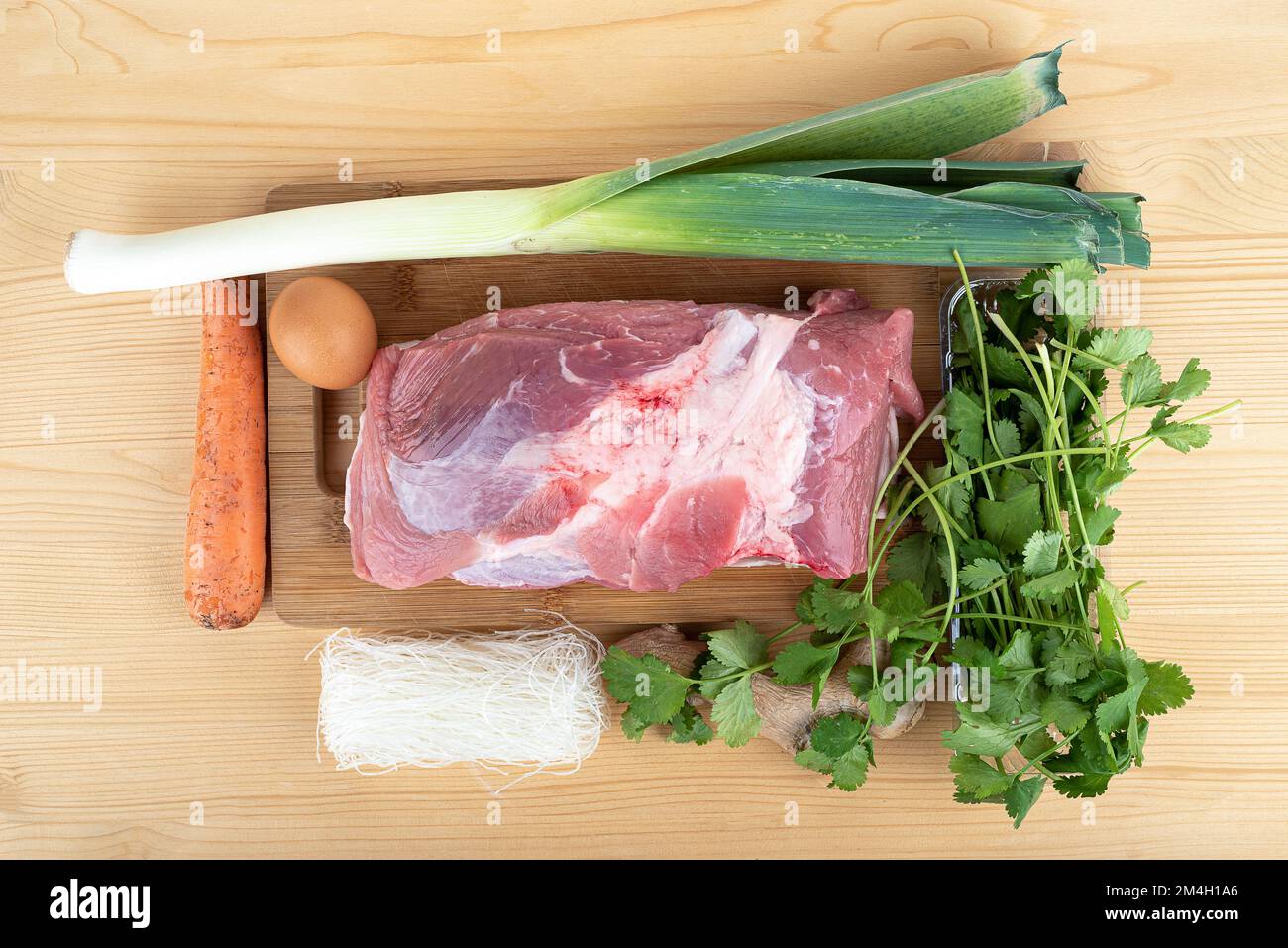 Top View Of A Set For Cooking Funchose And Pork Soup With Leeks Carrots And Cilantro Egg And