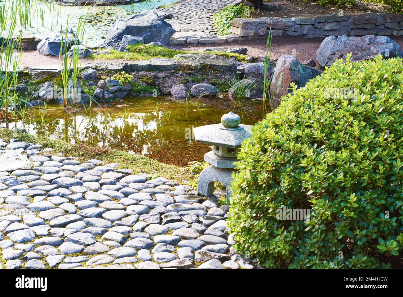 Japanese garden with stone path and pond Stock Photo - Alamy