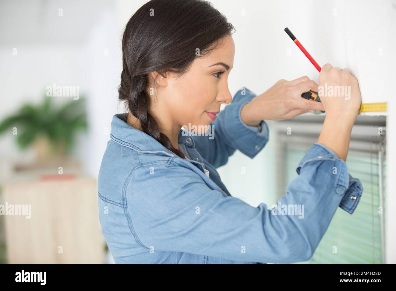 woman is measuring window frame Stock Photo - Alamy