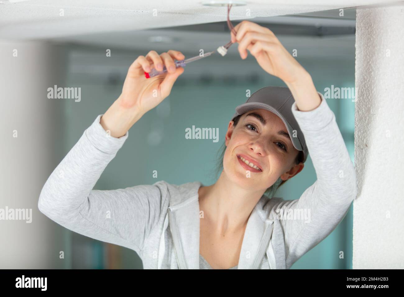 woman replacing light bulb at home Stock Photo - Alamy