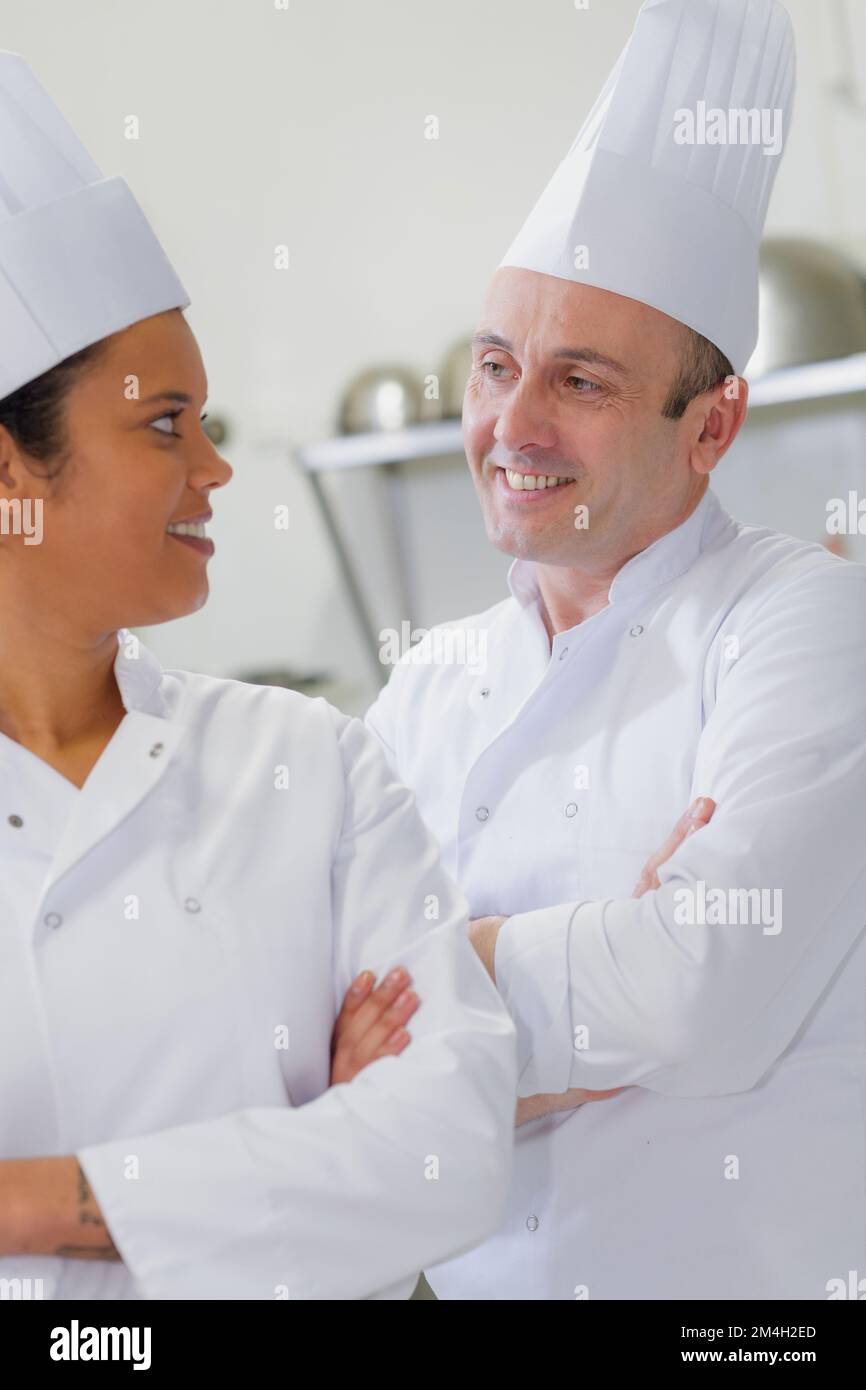 male and female chefs looking at eachother Stock Photo - Alamy