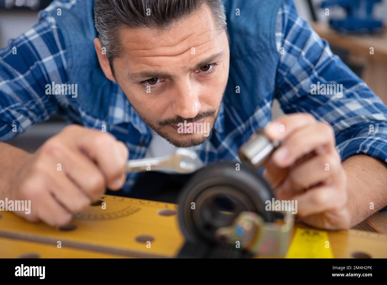 mechanic checking the car part in service station Stock Photo - Alamy