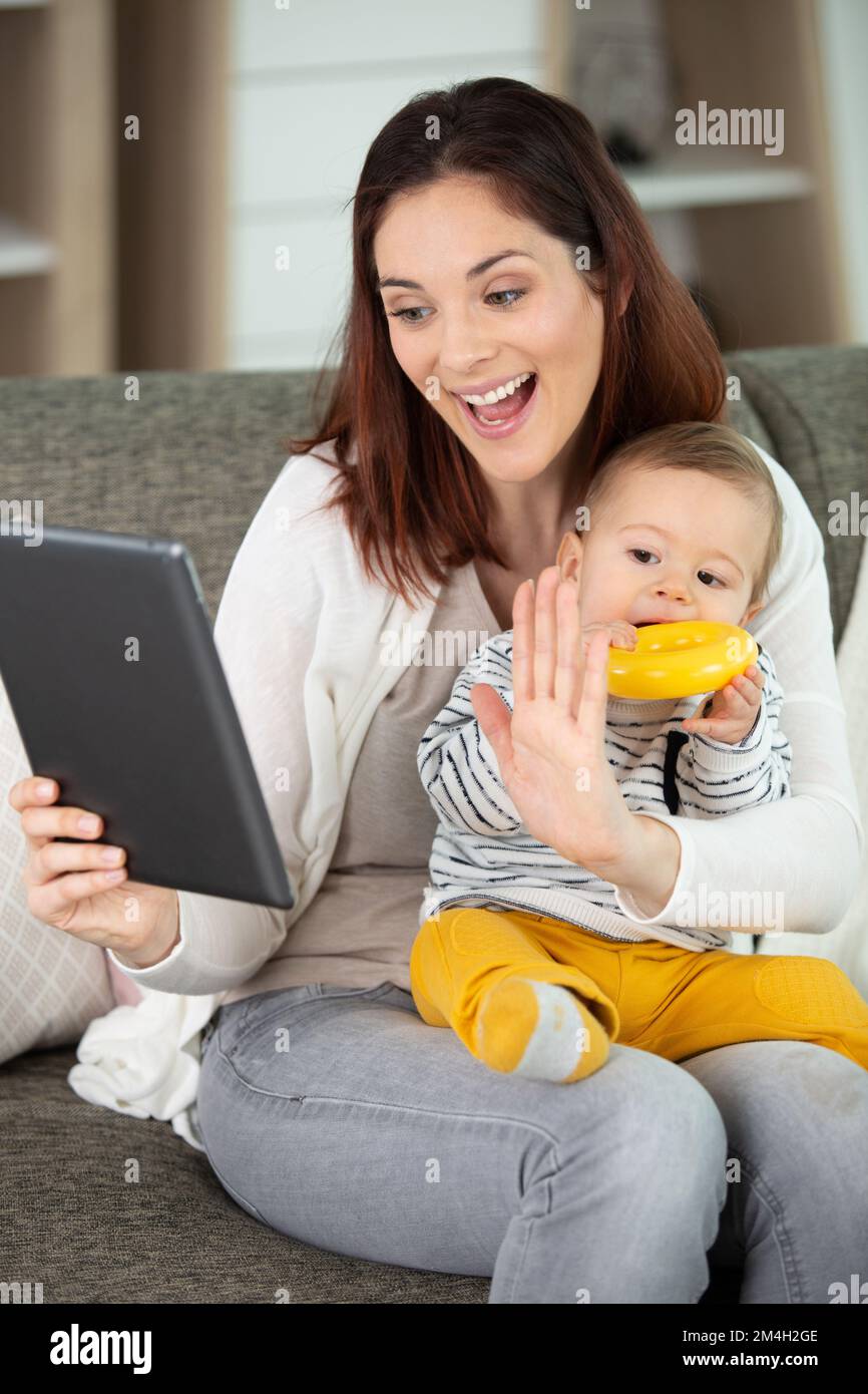 happy mom and cute kid baby using a tablet Stock Photo - Alamy