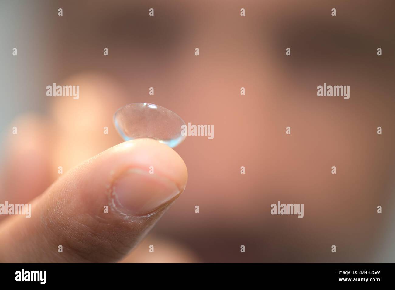 finger holds a contact lens Stock Photo - Alamy