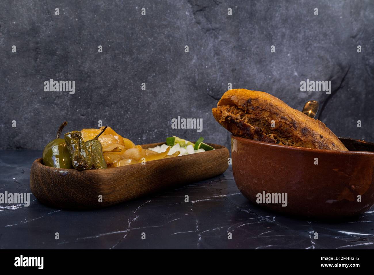 torta ahogada consome y birria, dish with onion, sweet onion and chile ...