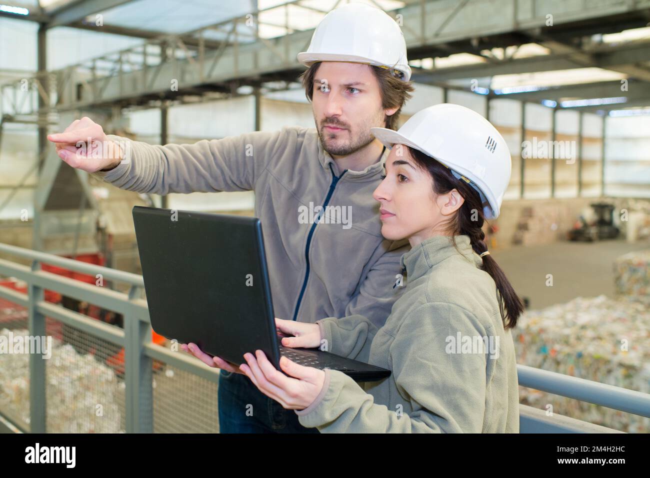supervisor of a recycle manufacturing business pointing Stock Photo - Alamy